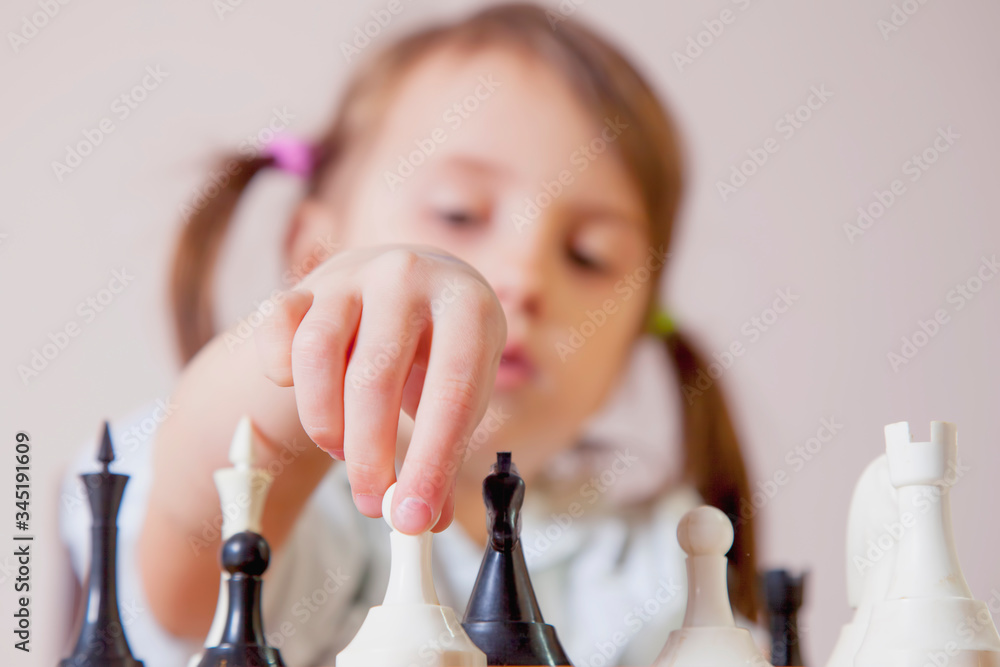 Young beautiful caucasian child girl p[aying chess. Development ...
