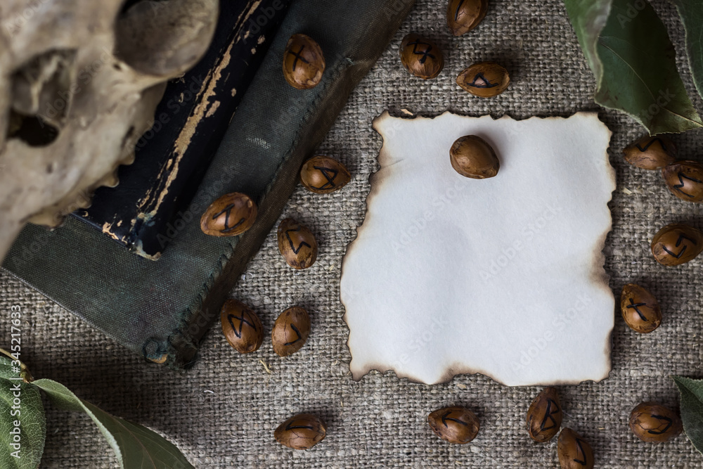 Empty rune (Odin's rune) lies on charred sheet, around the other runes ...