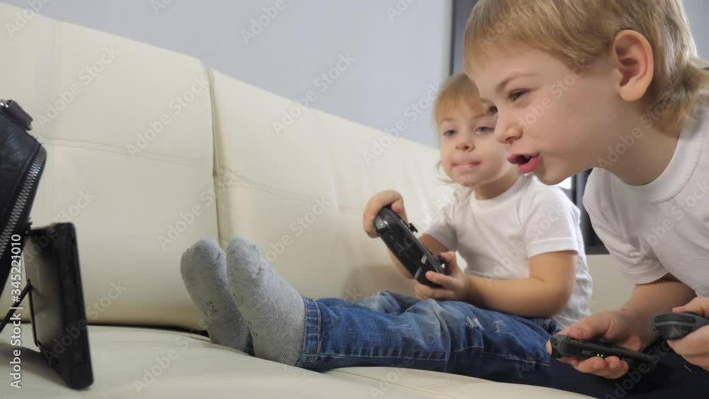 children play console in gamepads teamwork. kids a boy and lifestyle a ...