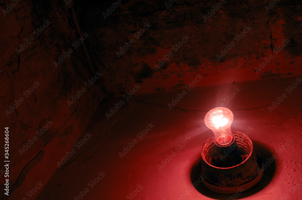 Anxiety concept. Alert symbol. Alarm lamp. Red bulb in dark red room ...