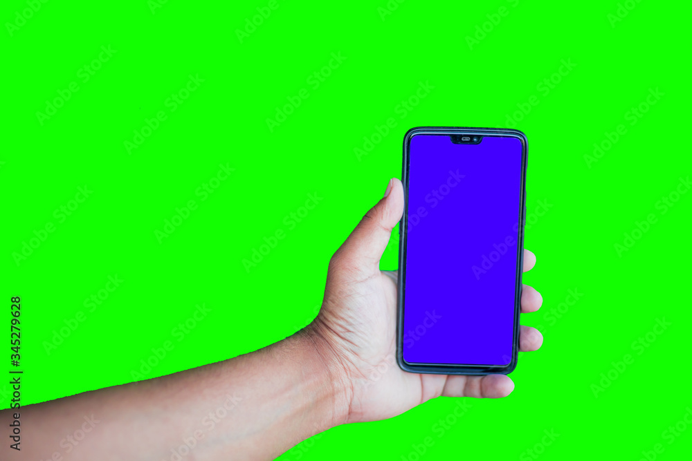 Man holding phone with chroma key display against the green screen ...