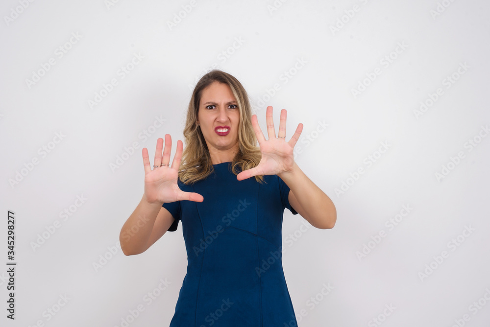 Dissatisfied female model frowns face, has disgusting expression, shows ...