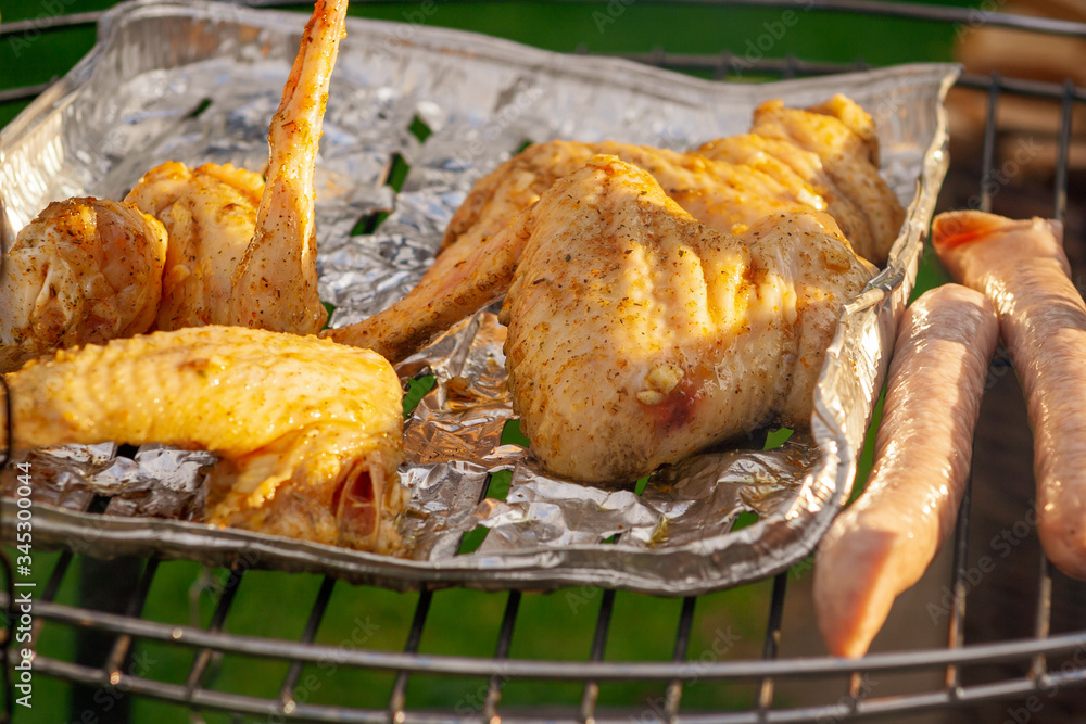 Ready to eat chicken wings during grill. Food on grill grate. Roast ...