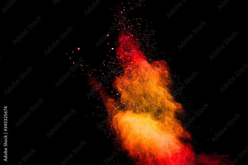 Red yellow powder explosion cloud on black background. Freeze motion of ...