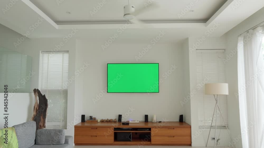LCD TV with green screen on the wall in modern living room with ...