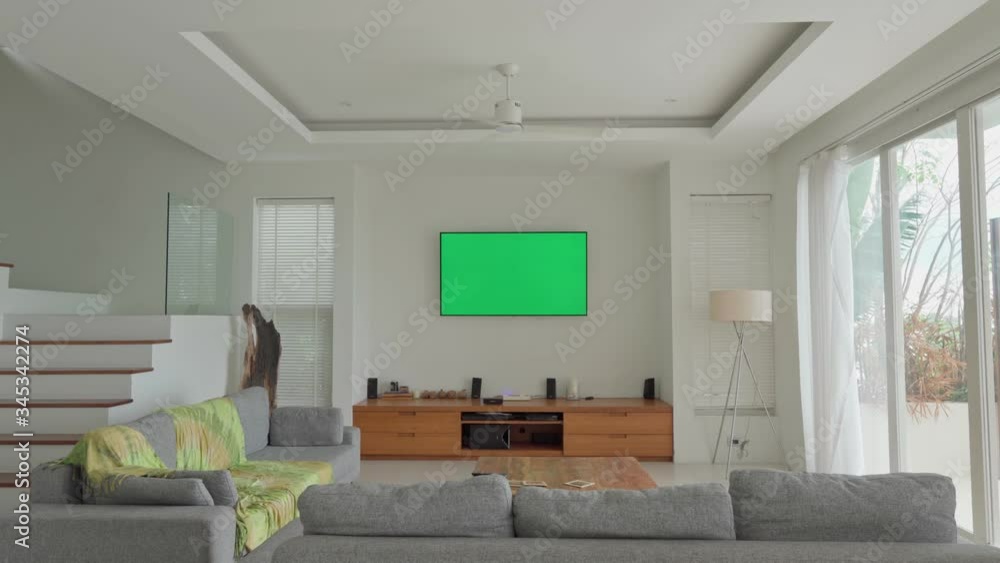 LCD TV with green screen on the wall in modern living room with ...