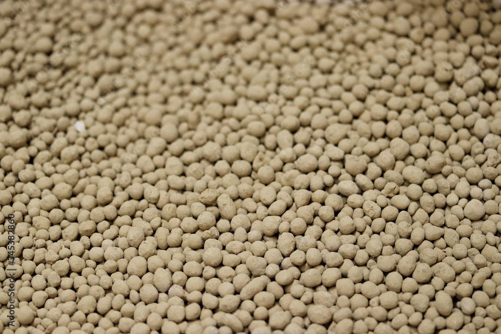 Magnesium lime fertilizer or fertiliser background, chemical granulated ...
