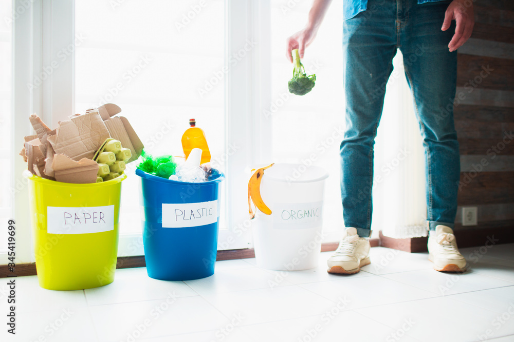 close-up concept. Sort garbage at home. There are three buckets for ...