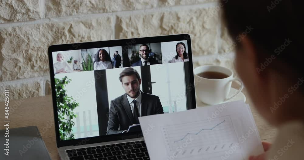 Over shoulder closeup view of business woman video conference calling ...