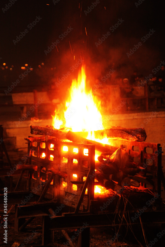 The funeral pyre. The ceremony of the cremation of Manikarnika Ghat on ...