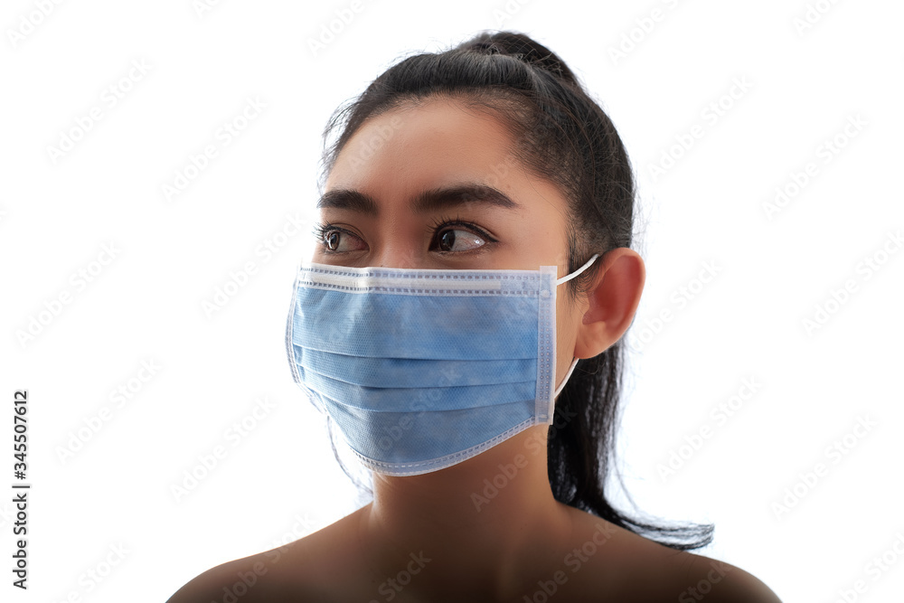 Beautiful young Asia woman putting on a medical mask to protect from airborne respiratory ...