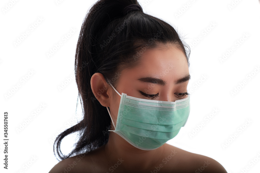 Beautiful young Asia woman putting on a medical mask to protect from airborne respiratory ...