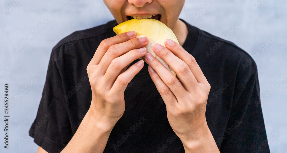 Close up A woman handle durian show the yellow durian meat to eat. The ...