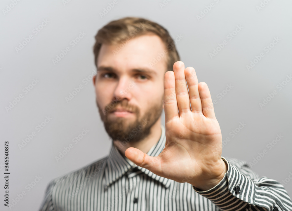 Closeup portrait of surprised helpless young man raising hand up to say ...
