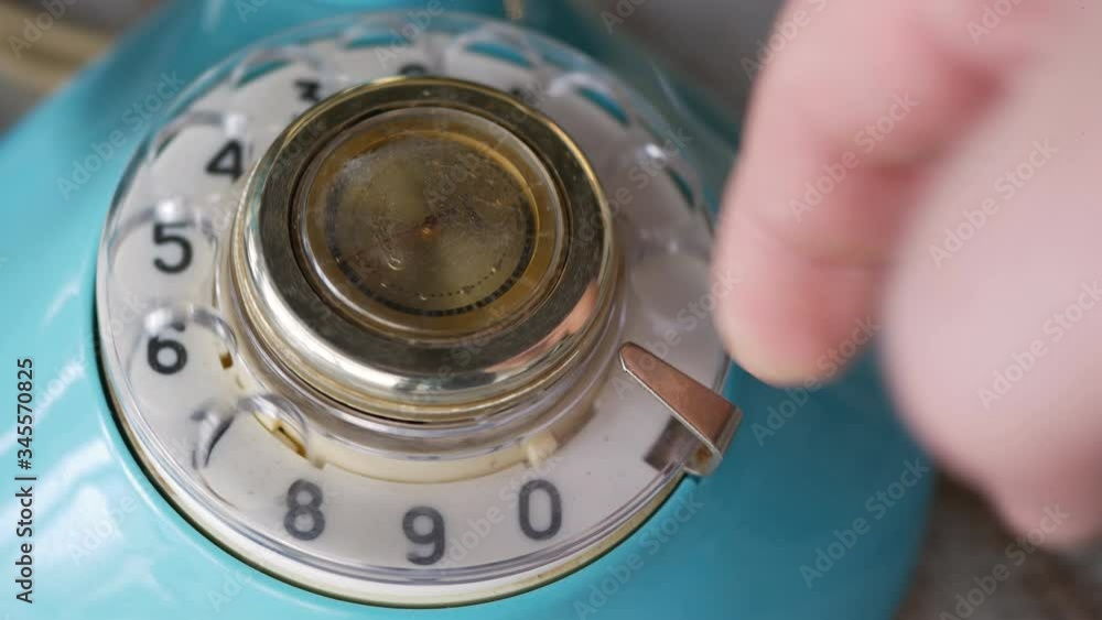 Close up view of old style telephone dialing. Antique blue telephone ...