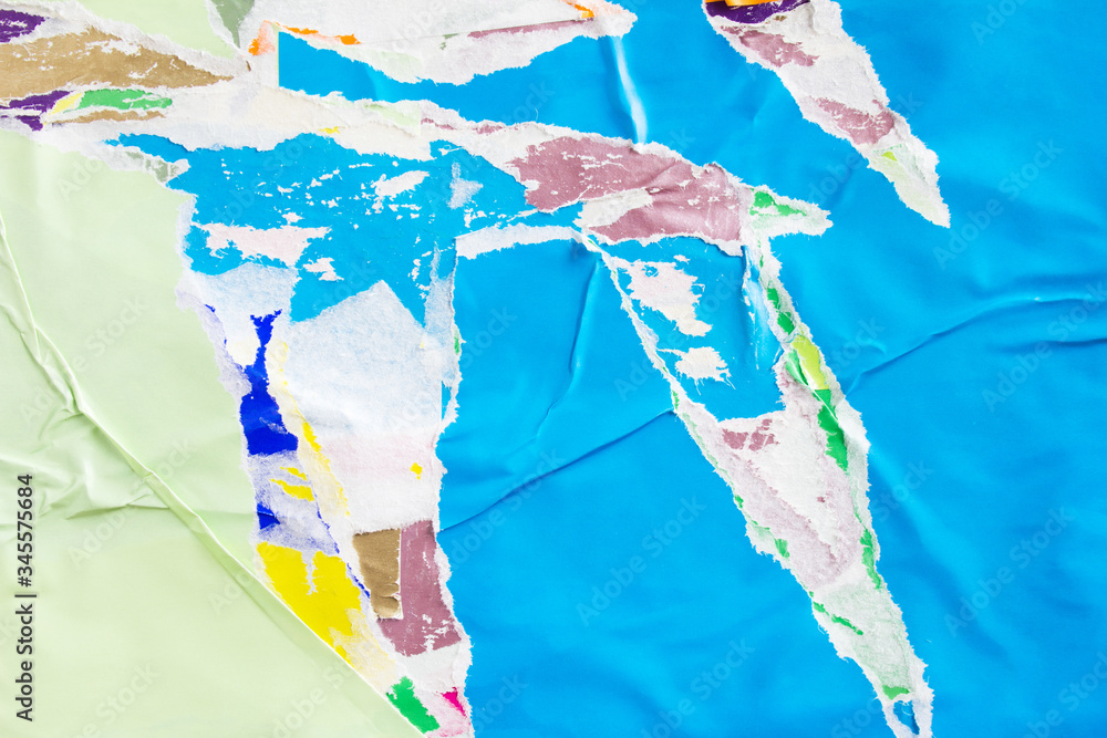 Blue and green torn and crumpled pieces of paper poster glued on a ...