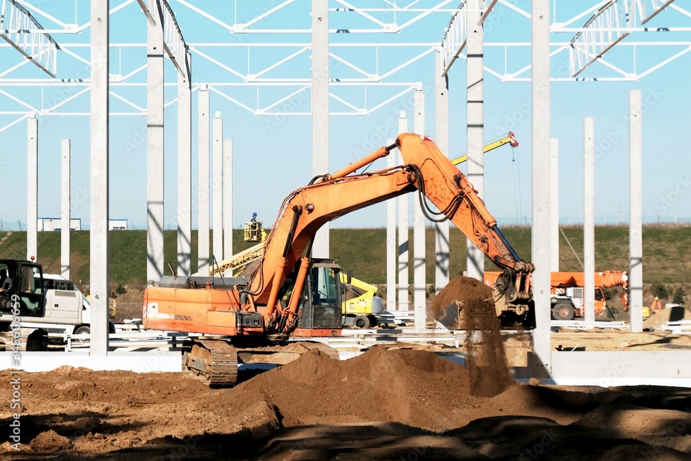 Construction site outside city, on edge of forest - concrete and steel ...