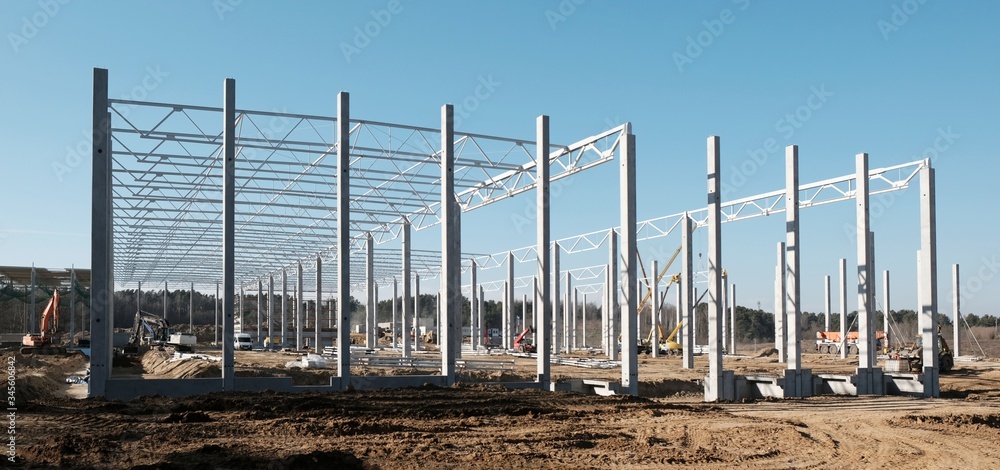 Construction site outside city, on edge of forest - concrete and steel ...