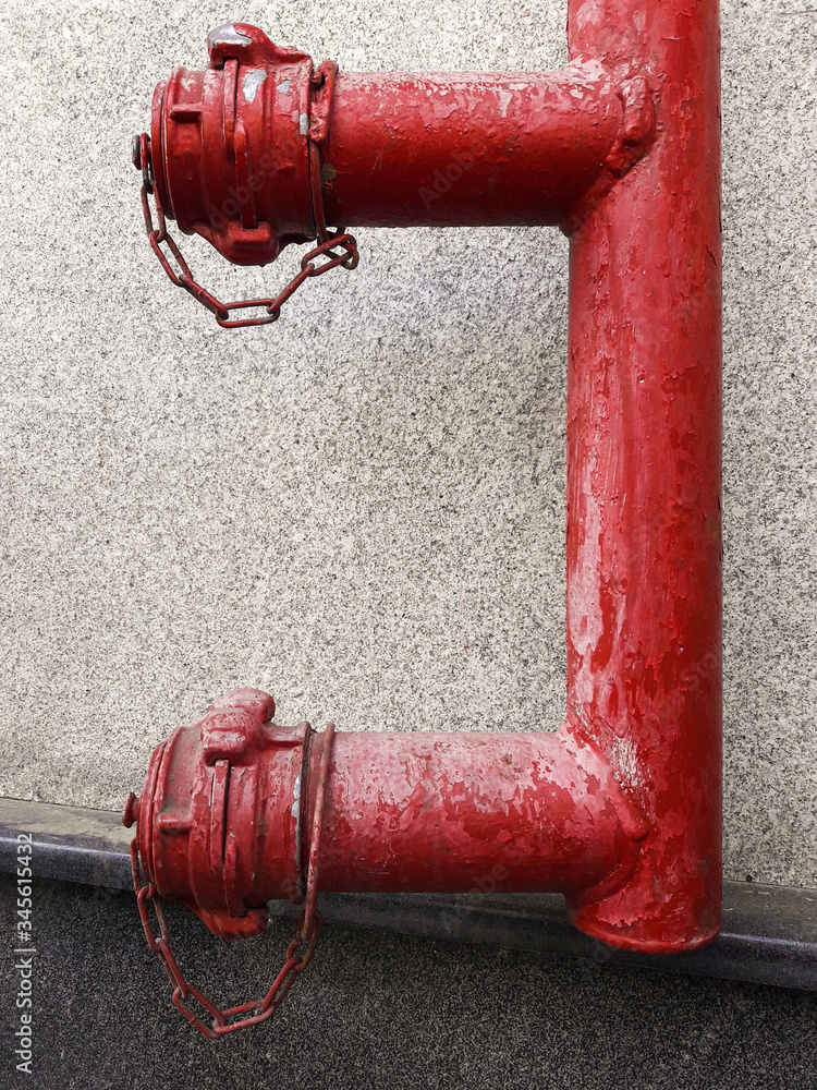 Summer, heat, city. In the frame one red old rusty fire hydrant. Color ...