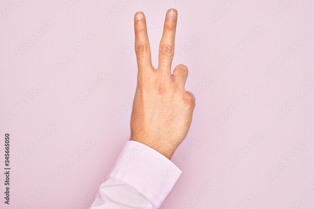 Hand of caucasian young man showing fingers over isolated pink ...