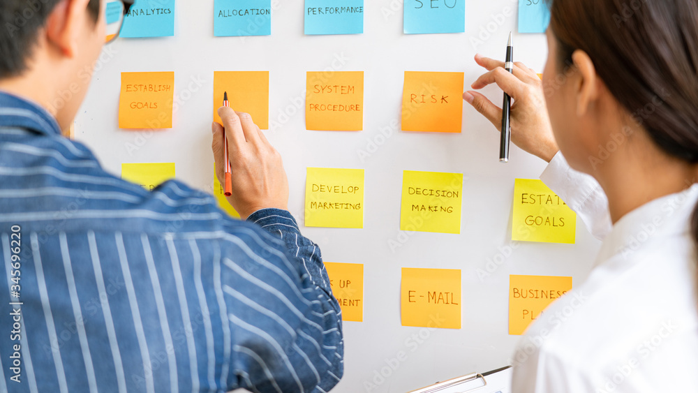 young business workers posting with sticky notes stickers reminders ...