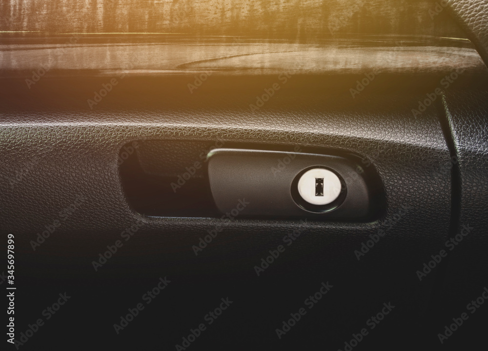 Keyhole for locking of car glove box compartment in a luxury car. Stock ...