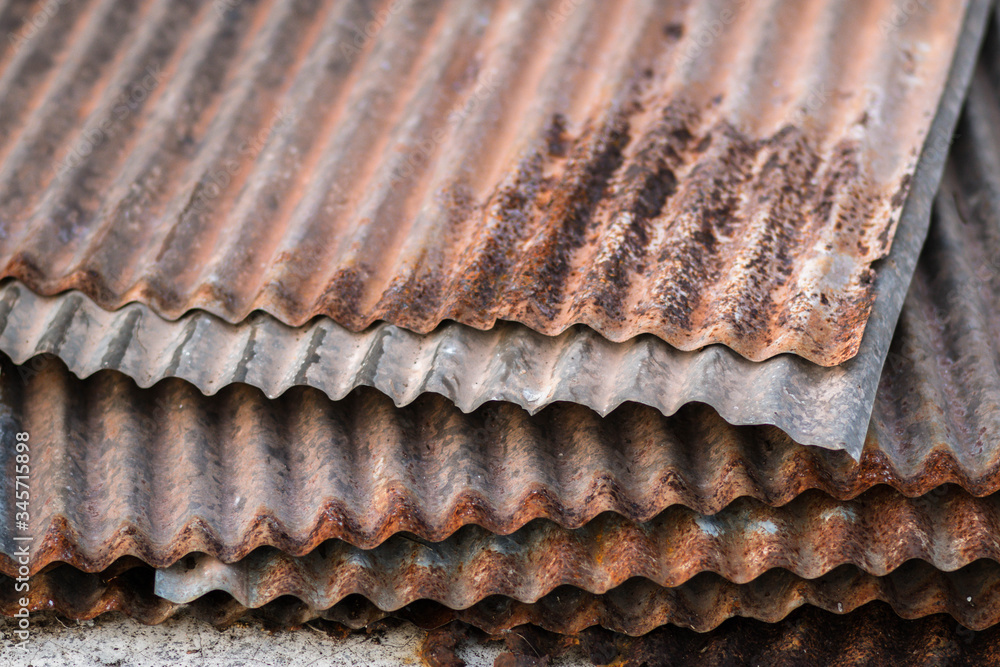 Sharp edges of the rusty metal sheets placed on the floor. Old aged ...