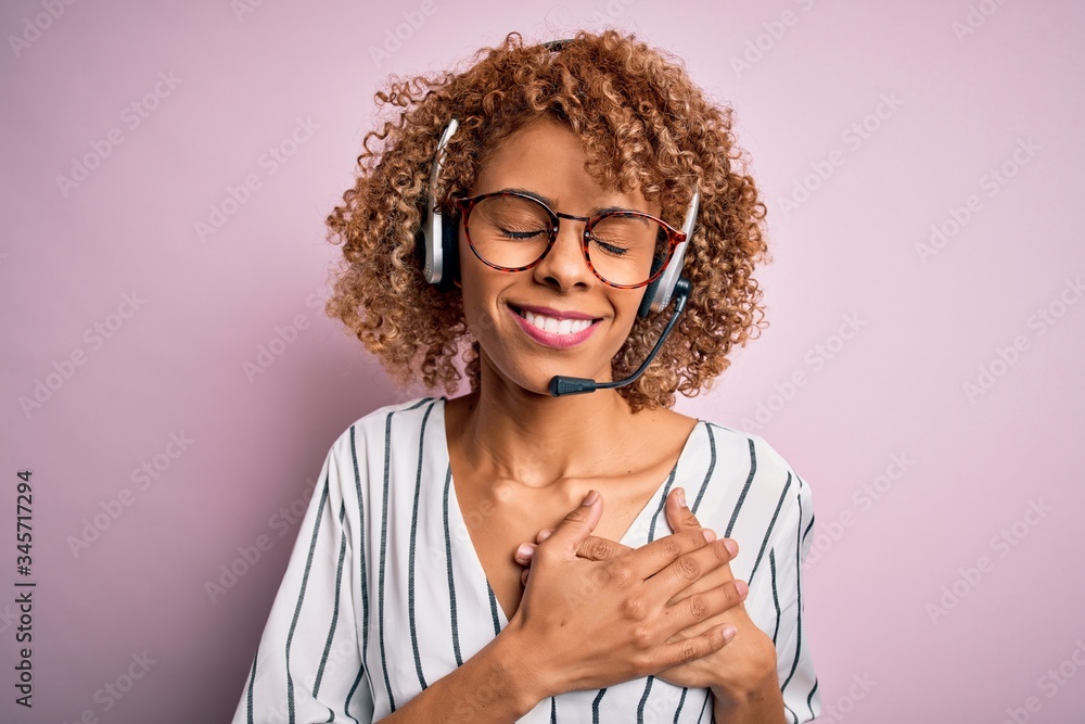 African american curly call center agent woman working using headset ...