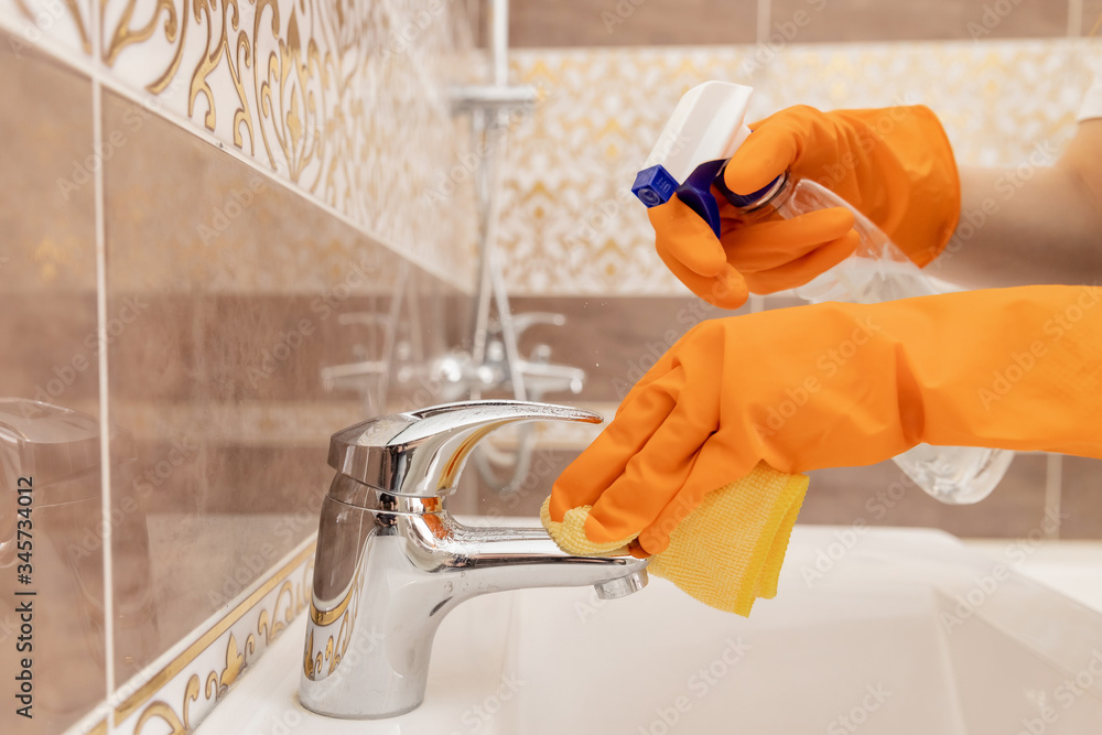 Cleaning tap from limescale in bathroom, disinfecting surface from ...