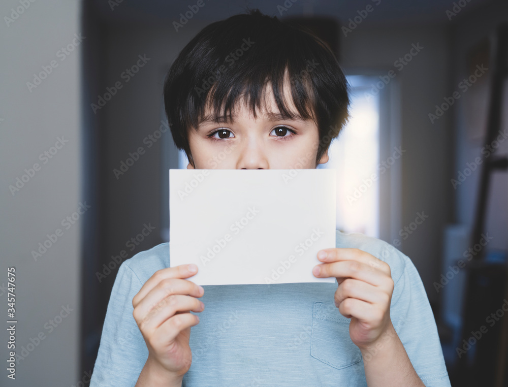 Portrait of sad kid holding empty white paper, Lonely child boy showing ...