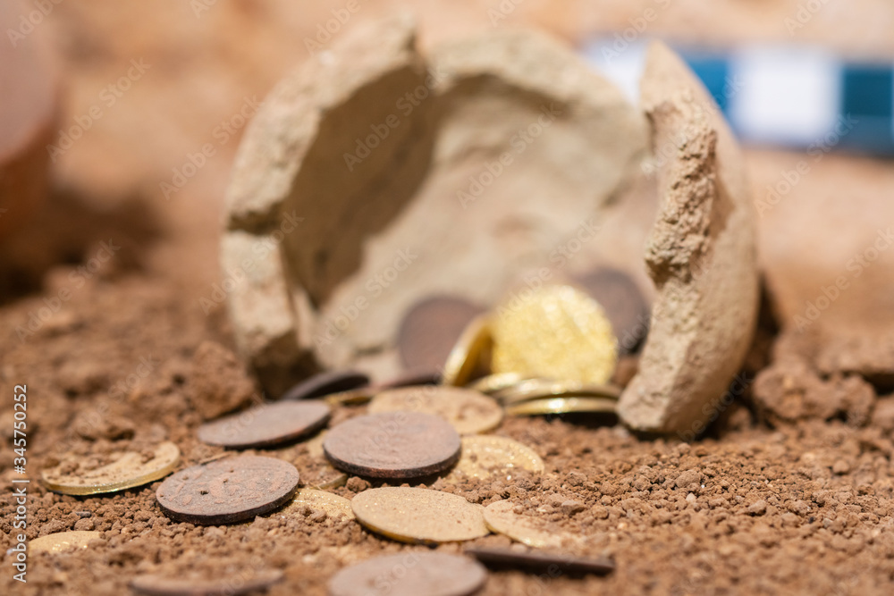 Antique coins in an ancient pottery jug. Old mesopotamia money. The ...