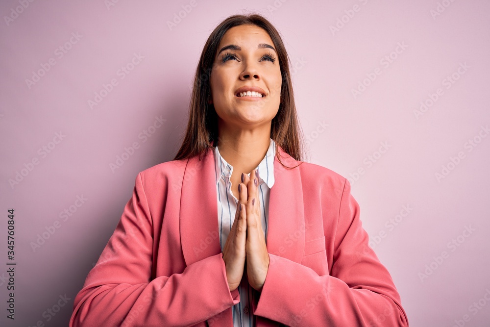 Young beautiful brunette woman wearing jacket standing over isolated ...