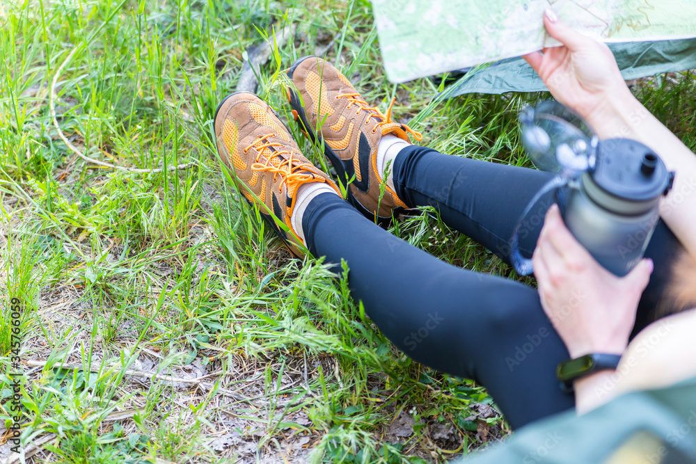 Beautiful girl is sitting in the hiking tent and looking at map. A girl ...