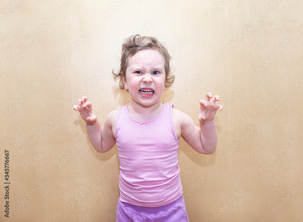 Child, girl, emotions on the face. The girl bared and growls. Copy ...