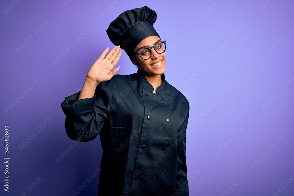 Young african american chef girl wearing cooker uniform and hat over ...