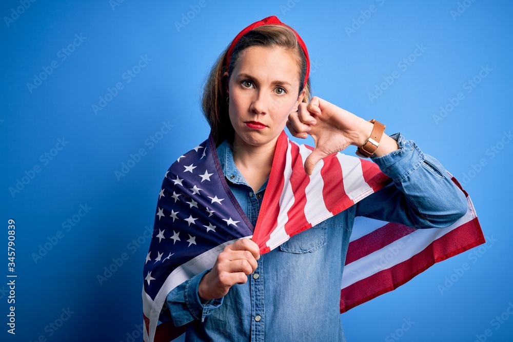 Young beautiful blonde woman wearing United States flag over isolated ...
