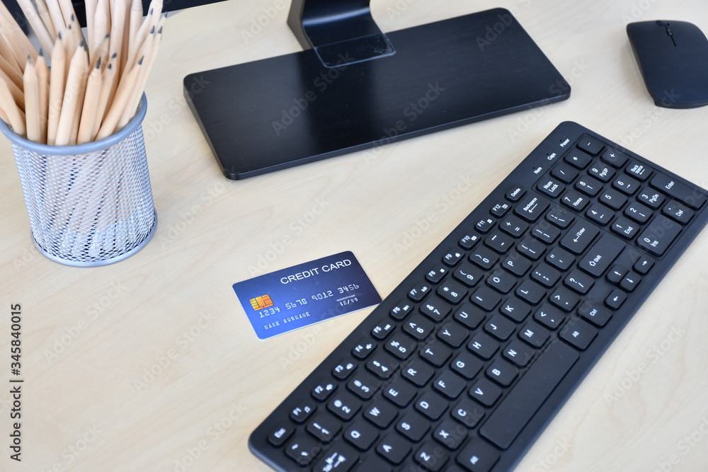 Credit cards are placed on the work desk with the desktop computer in ...