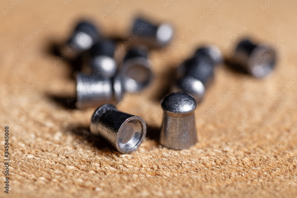 Lead bullets for an air rifle on a tree cut Stock Photo | Adobe Stock