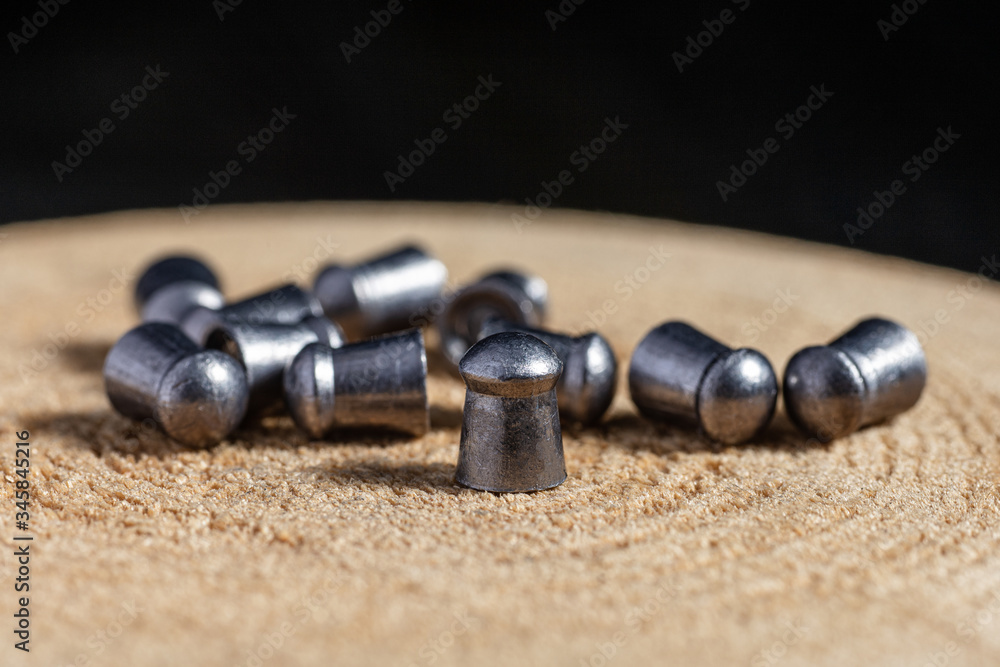 Lead bullets for an air rifle on a tree cut Stock Photo | Adobe Stock