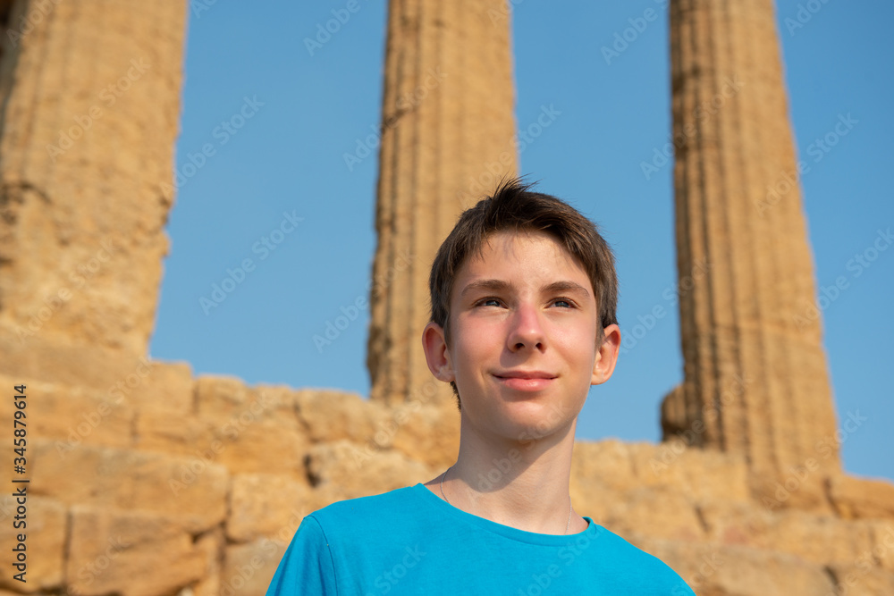 Handsome cheerful teen boy against ancient Greek Temple, Agrigento ...