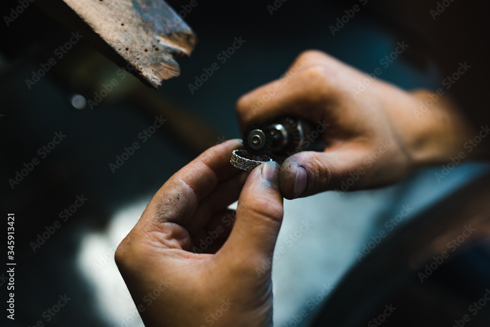 Master of jewelry while working on making a gold ring. Top view. Stock ...