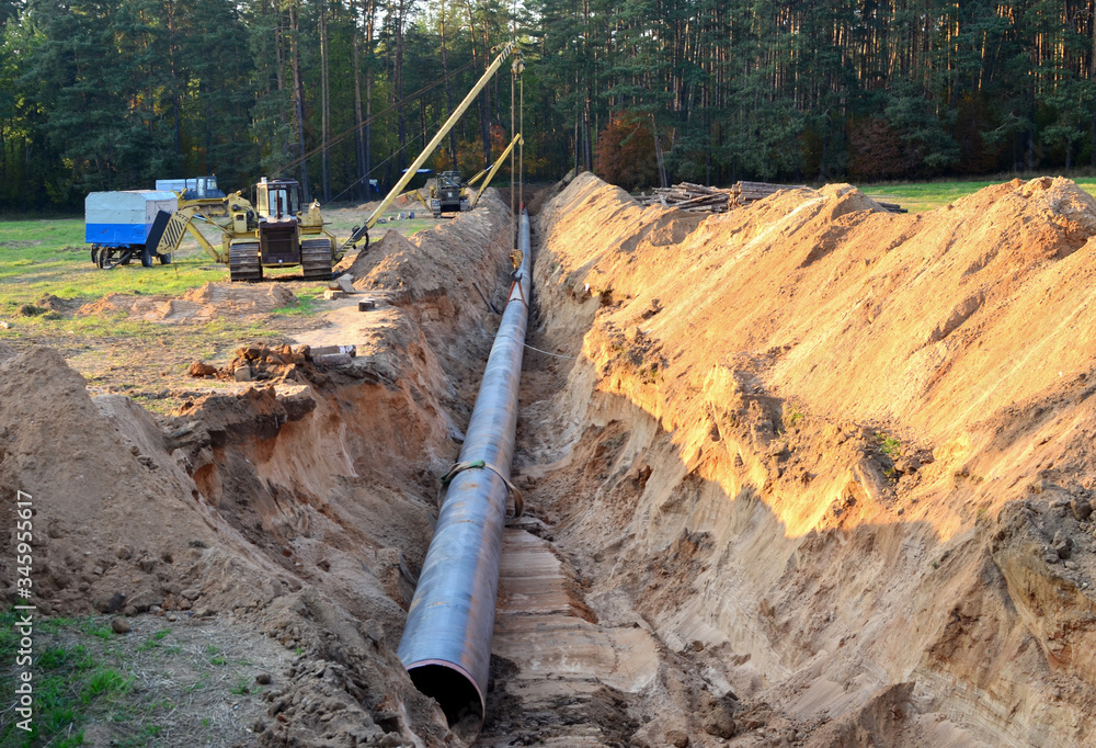 Natural gas pipeline construction work. A dug trench in the ground for ...