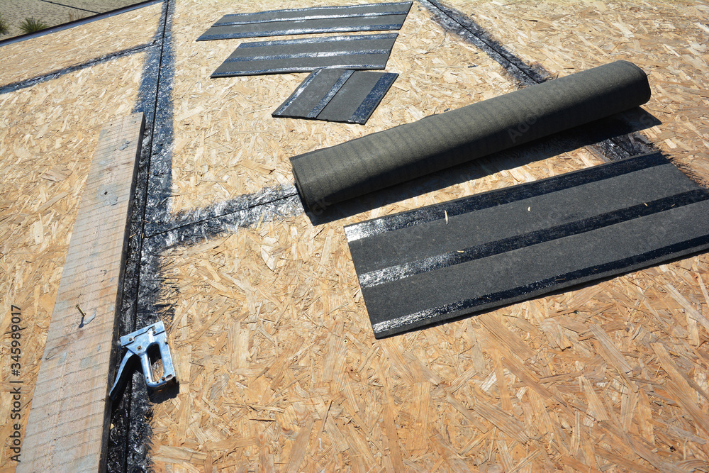 Preparing a roof deck and working tool stapler, having the surface of ...