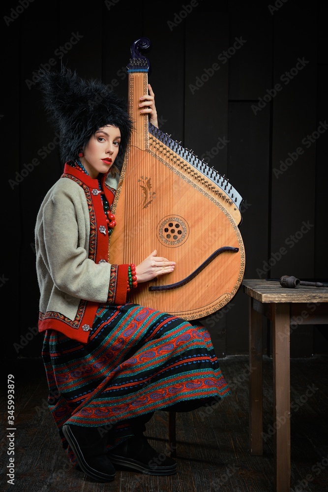 Gorgeous young woman in ukrainian traditional costume with ukrainian ...