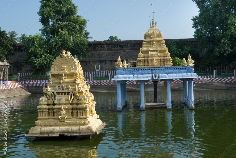 view of temple pond with mandapams and gopurams inside ...