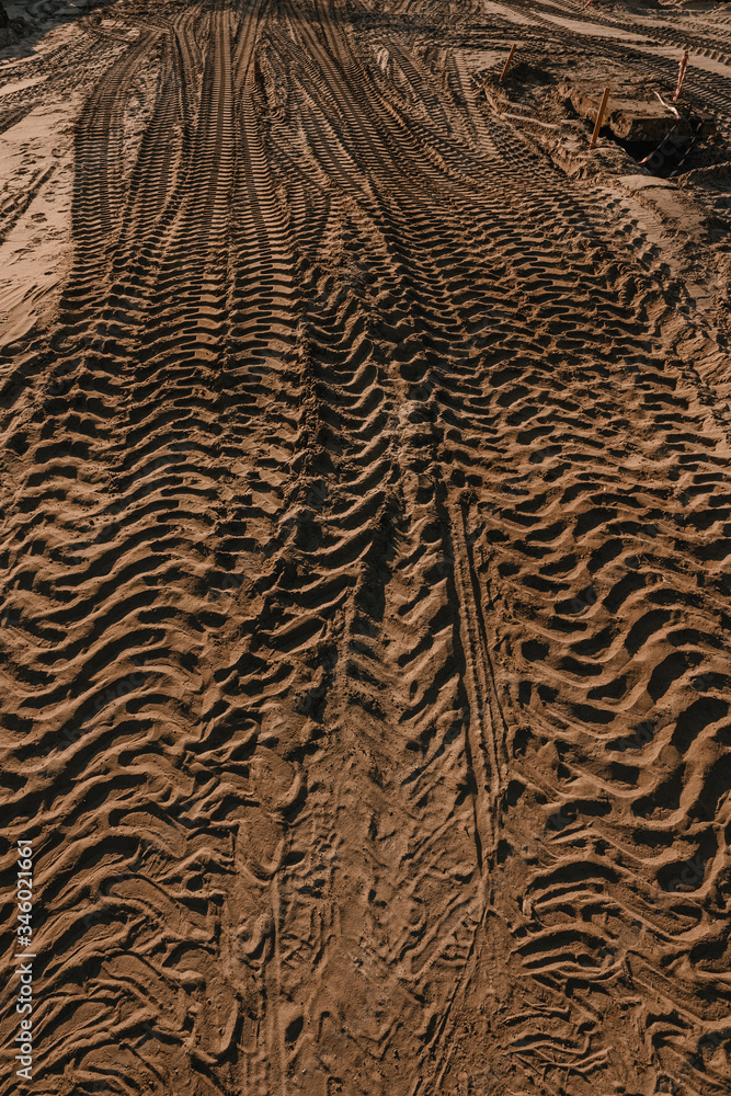 Footprints in the sand from trucks. Construction machinery. Patterns in ...