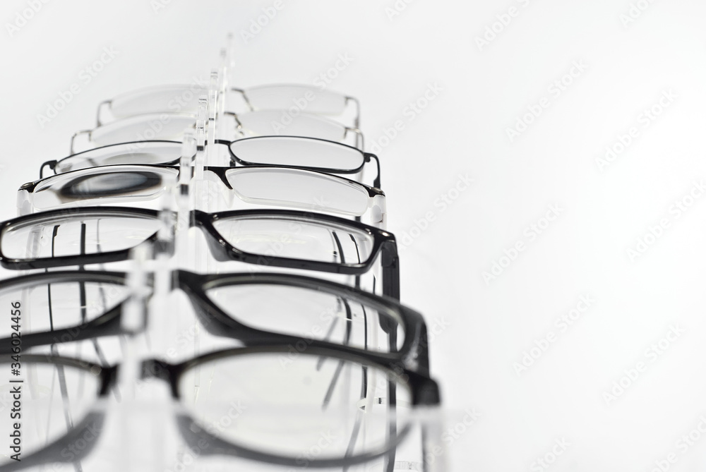 Many glasses on a white background. Glasses are stacked in a row on a ...