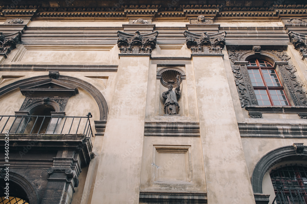 Antique baroque windows and balcony by decorative stucco on a beige ...