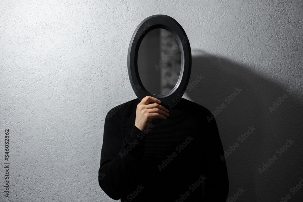 Dramatic portrait of man with black mirror on face. Background of white ...