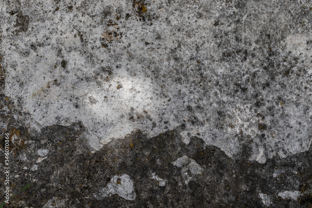 Old and deteriorated stone texture with remains of moss and vegetation ...
